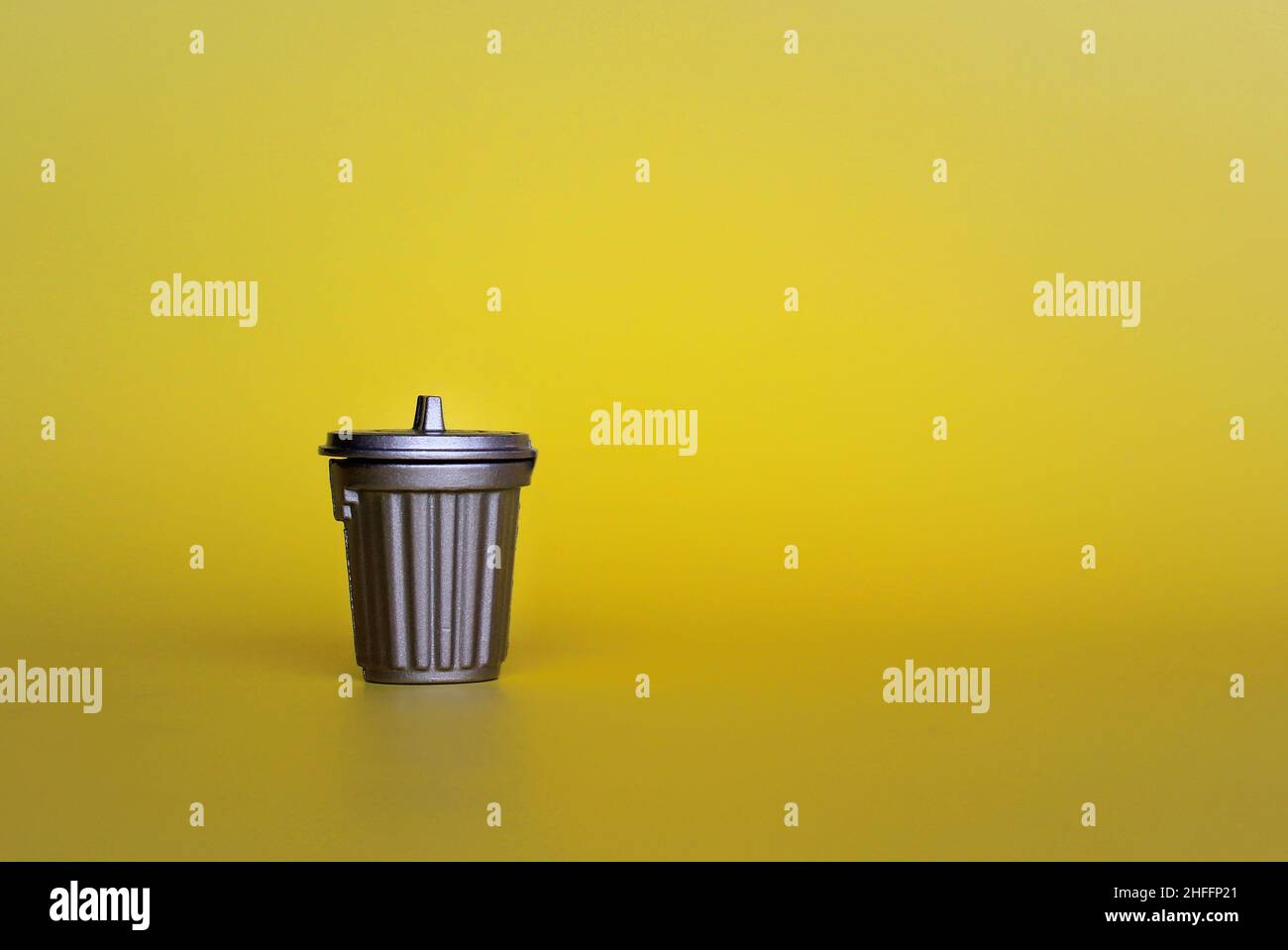 Close up image of trash can on yellow background with copy space Stock ...