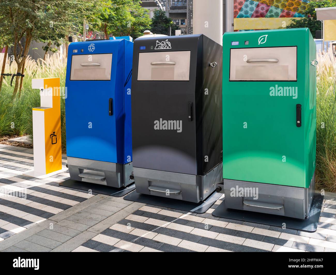 Trash cans and sanitizer on the street in Dubai Stock Photo - Alamy