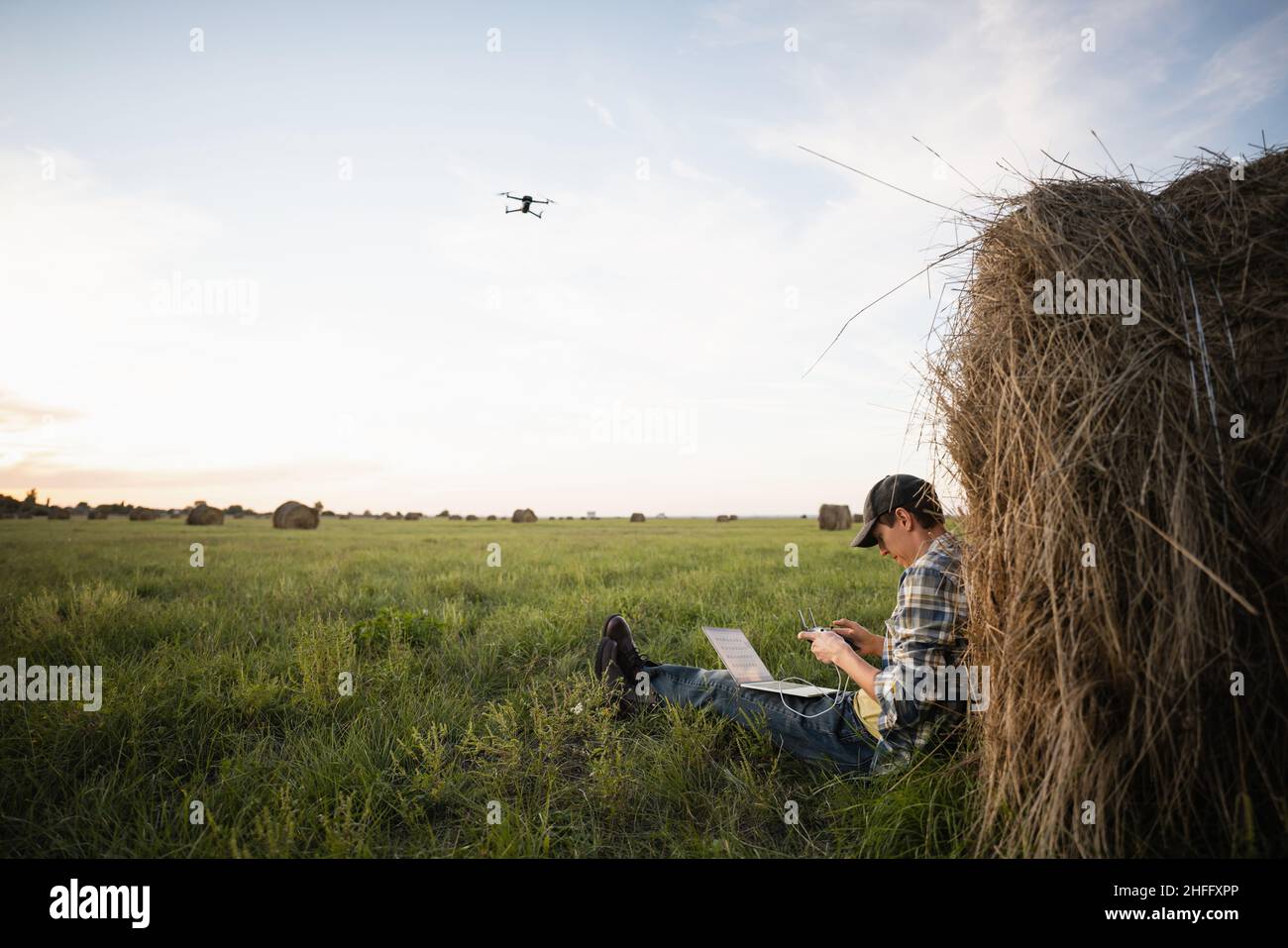 Farmer with laptop and drone on the field. Smart farming and ...