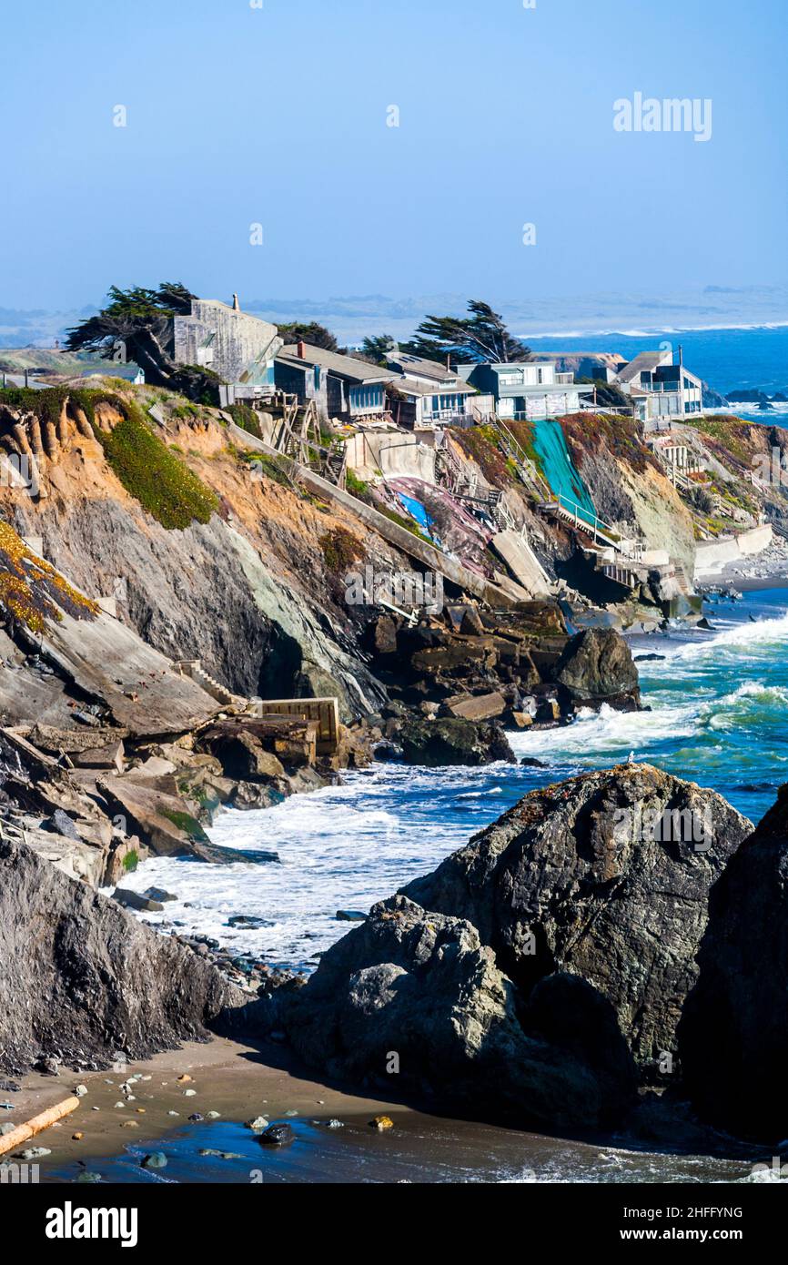 wooden houses at wild pacific coast with cliffs and huge waves Stock ...