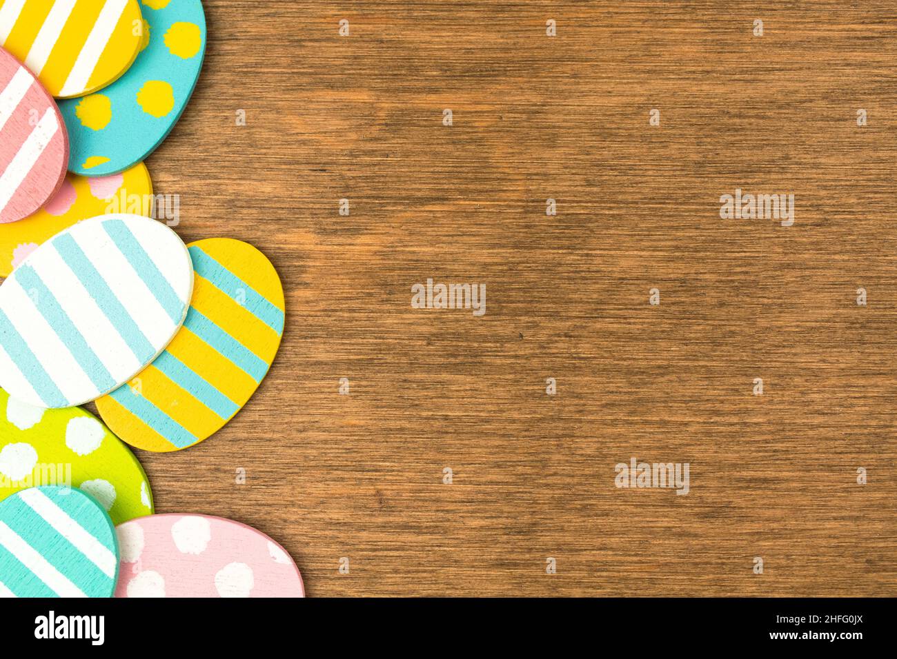 Colorful Easter eggs border, old rustic wood background, flat lay ...