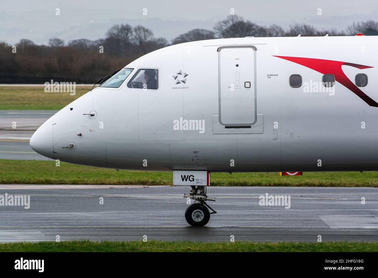 The nose of an Austrian Embraer 195 at Manchester Airport Stock Photo ...