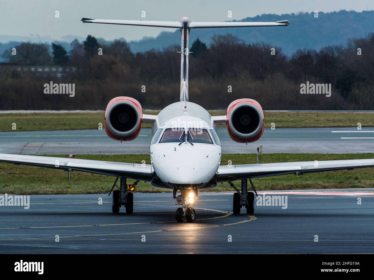 A Loganair Embraer 145 taxiing to the gate at Manchester Airport Stock ...
