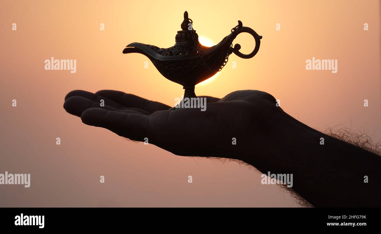 aladdin magic lamp in sky with sun Stock Photo - Alamy