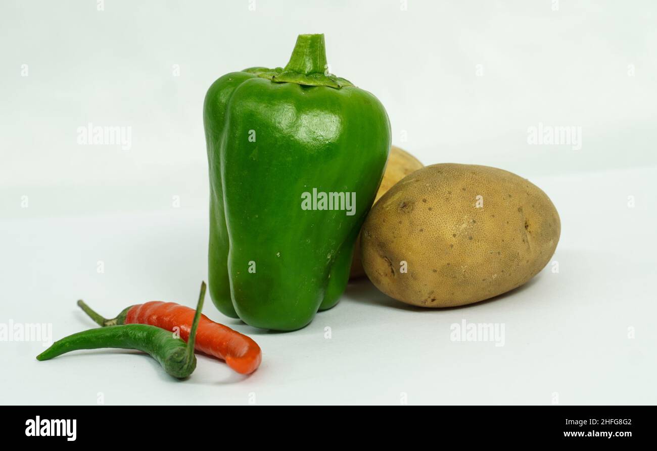 fresh vegetables capsicum chillie and potato on white background Stock ...