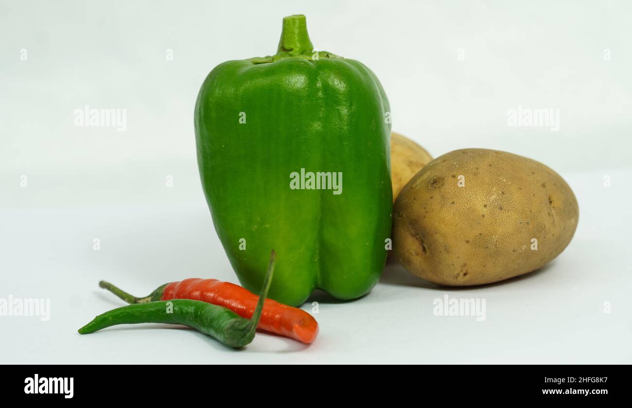 fresh vegetables capsicum chillie and potato on white background Stock ...