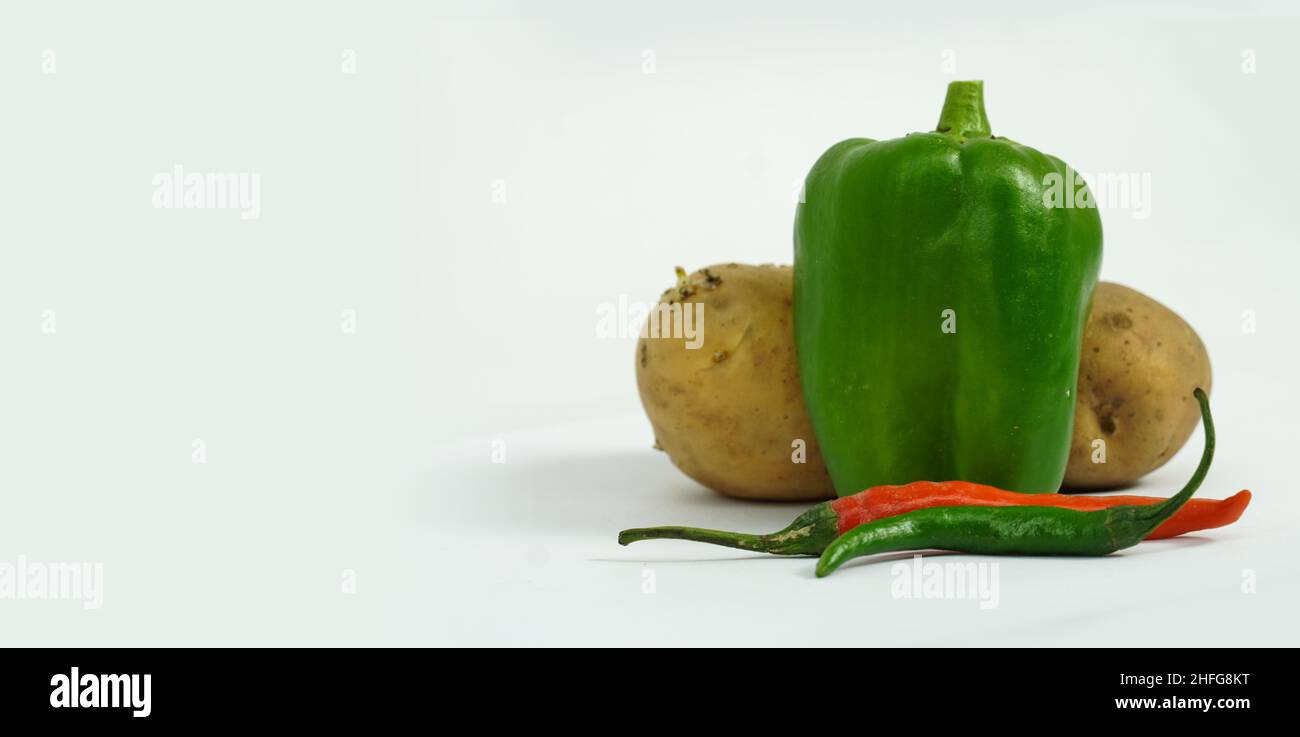 fresh vegetables capsicum chillie and potato on white background Stock ...