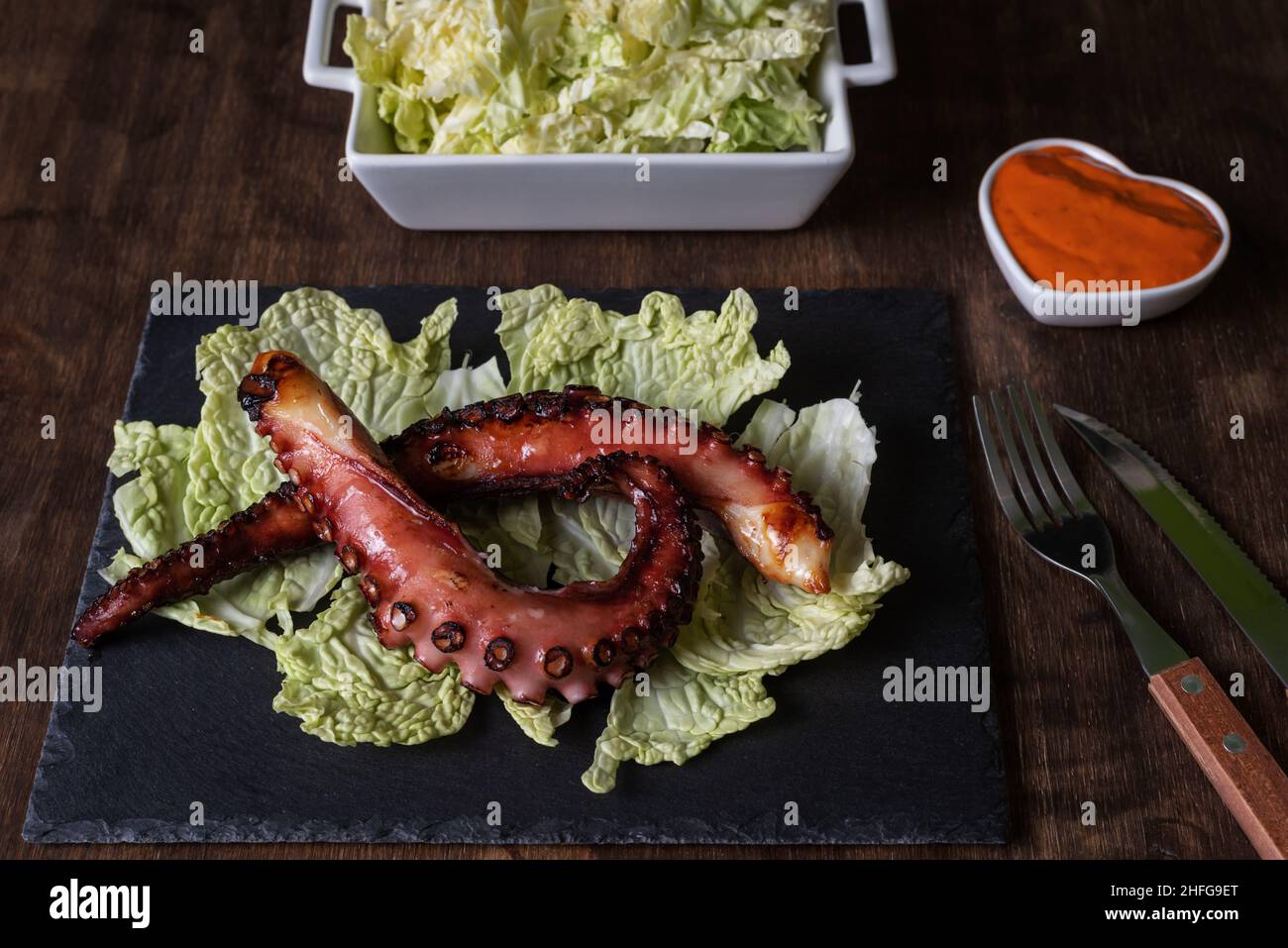 Dry octopus legs, dried according to tradition, served on a bed of ...