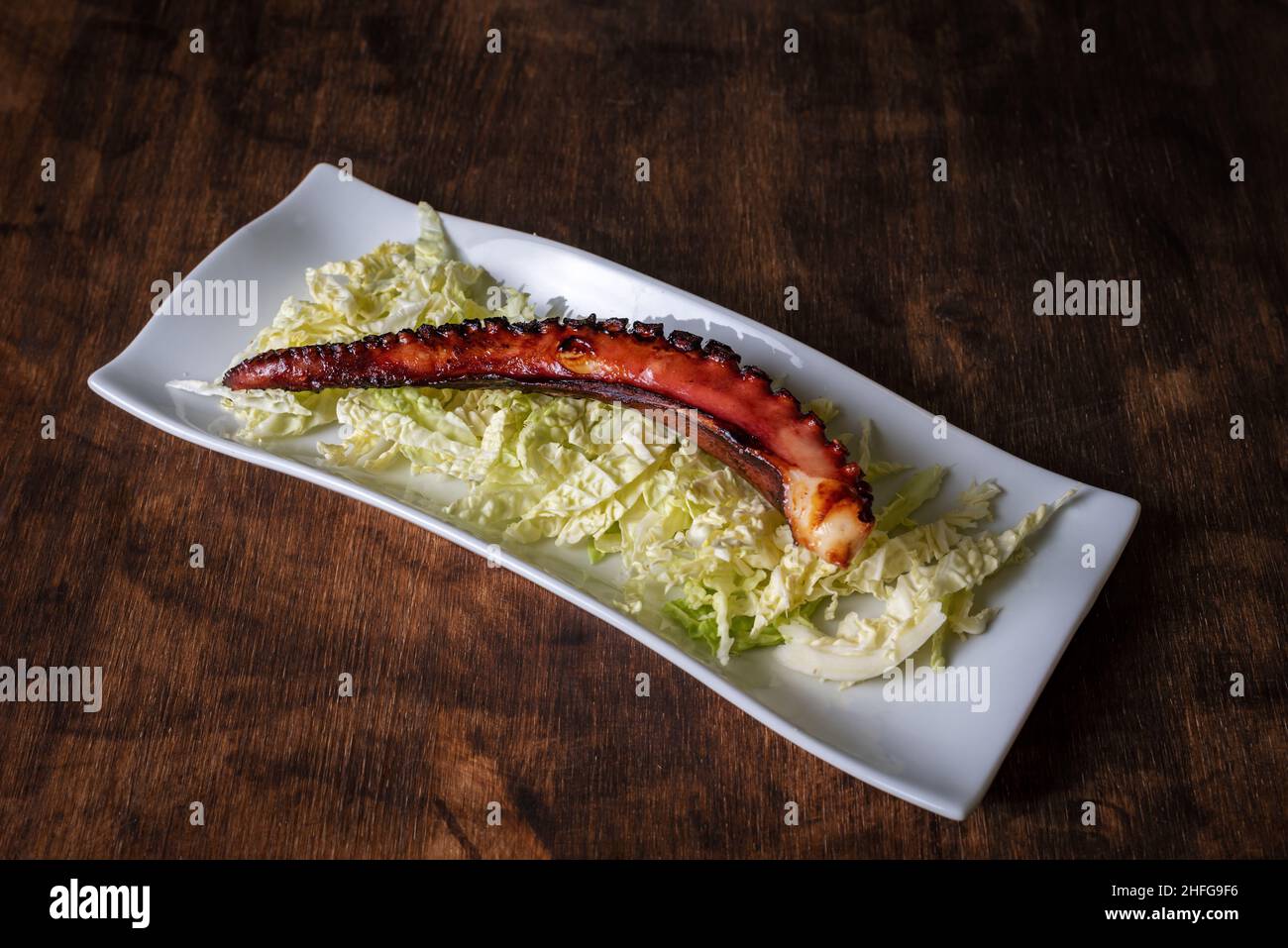 Dry octopus leg, dried according to tradition, served on a bed of ...