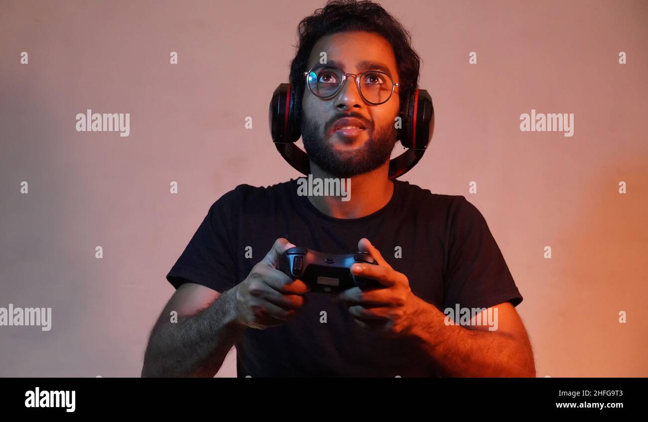 man playing game wusing gaming wireless joystick Stock Photo - Alamy
