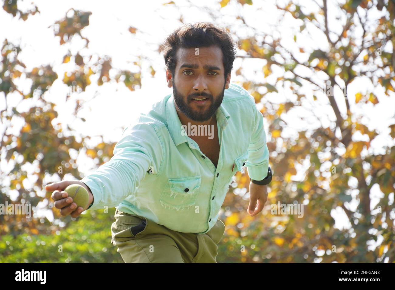 man stamping in match using cricket ball Stock Photo - Alamy
