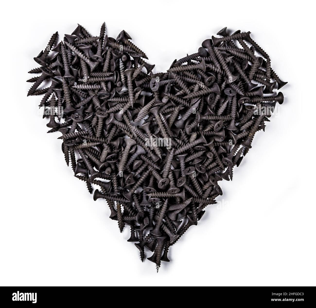 A heart shaped figure laid out from black screws isolated on white ...