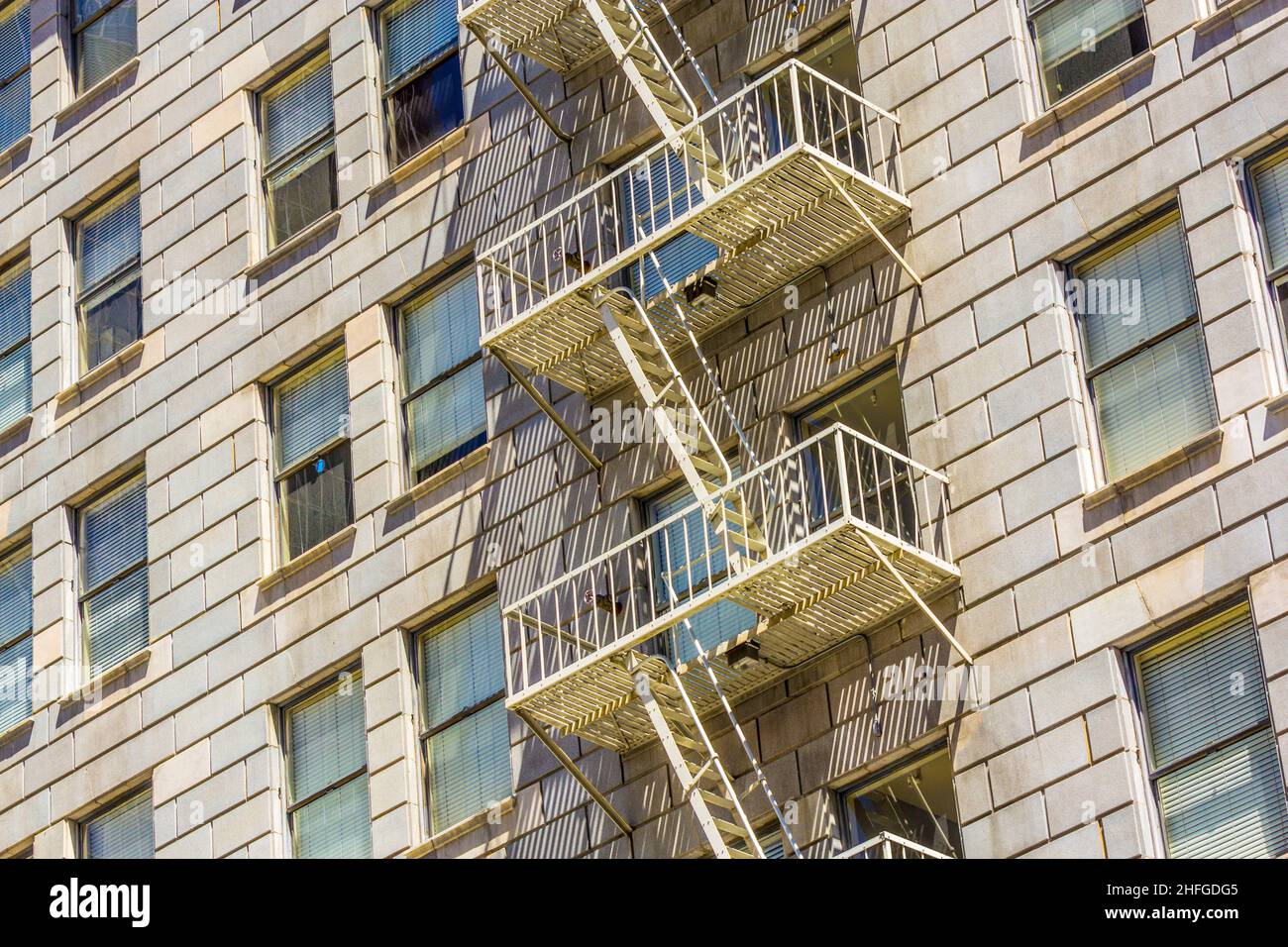 facade of historic skyscraper downtown Los Angeles with fire escape ...