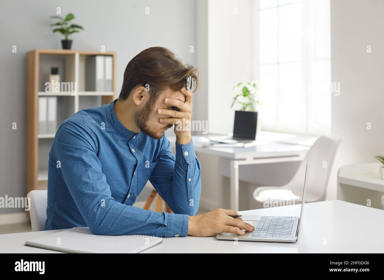 Stressed, exhausted and frustrated young employee has a burnout at work ...