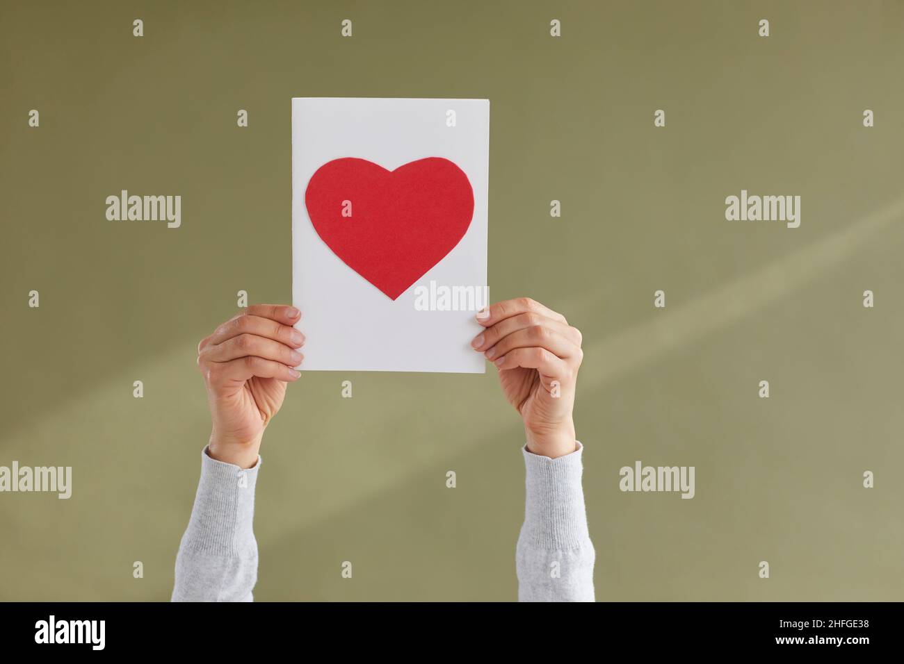 Person hold paper with red heart sign Stock Photo - Alamy