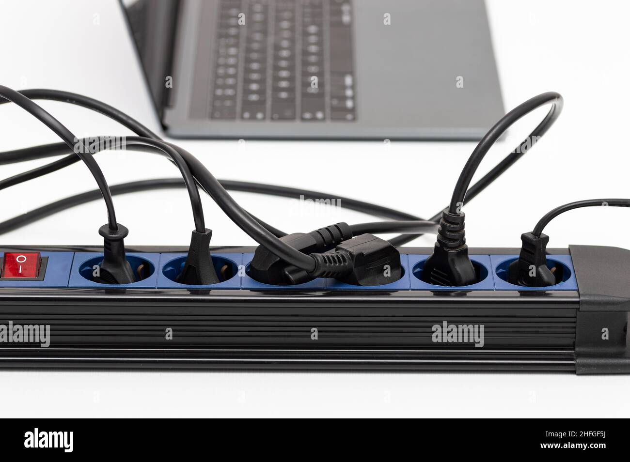 Close up of a plug in an electrical socket on a table at home with many ...