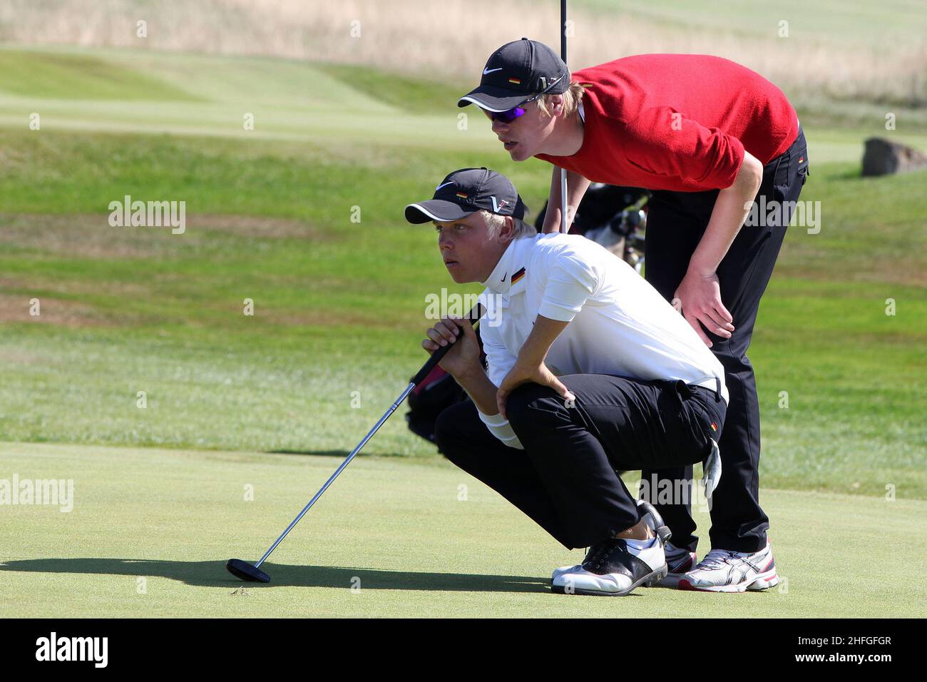 MAX ROTTLUFF, German golfer, checking the putting line with the help of ...
