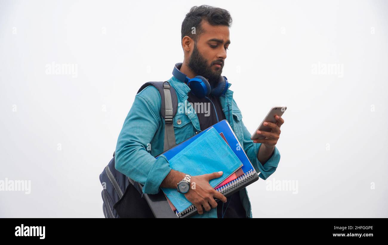 young boy using mobile phone at collage in withe background Stock Photo ...