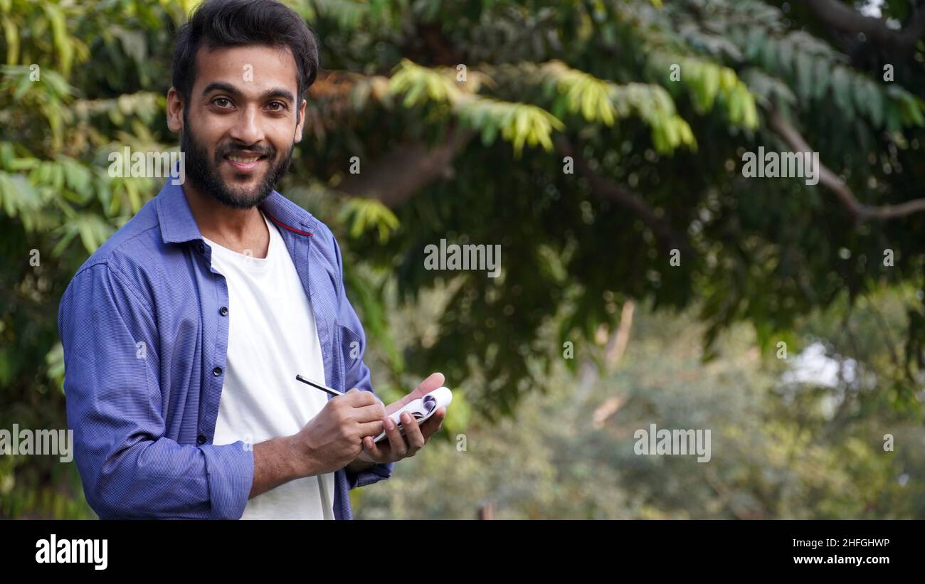 Happy Man With Notepad ready to write - Indian man Image Stock Photo ...