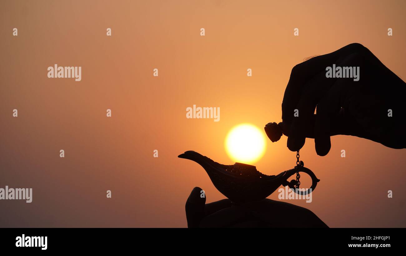 aladdin magic lamp in sky with sun Stock Photo - Alamy