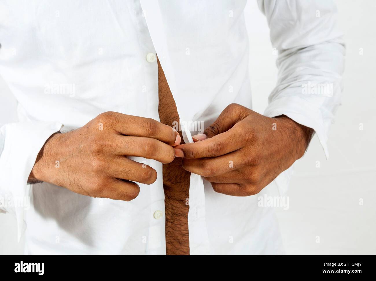 man buttoning his shirt Stock Photo - Alamy