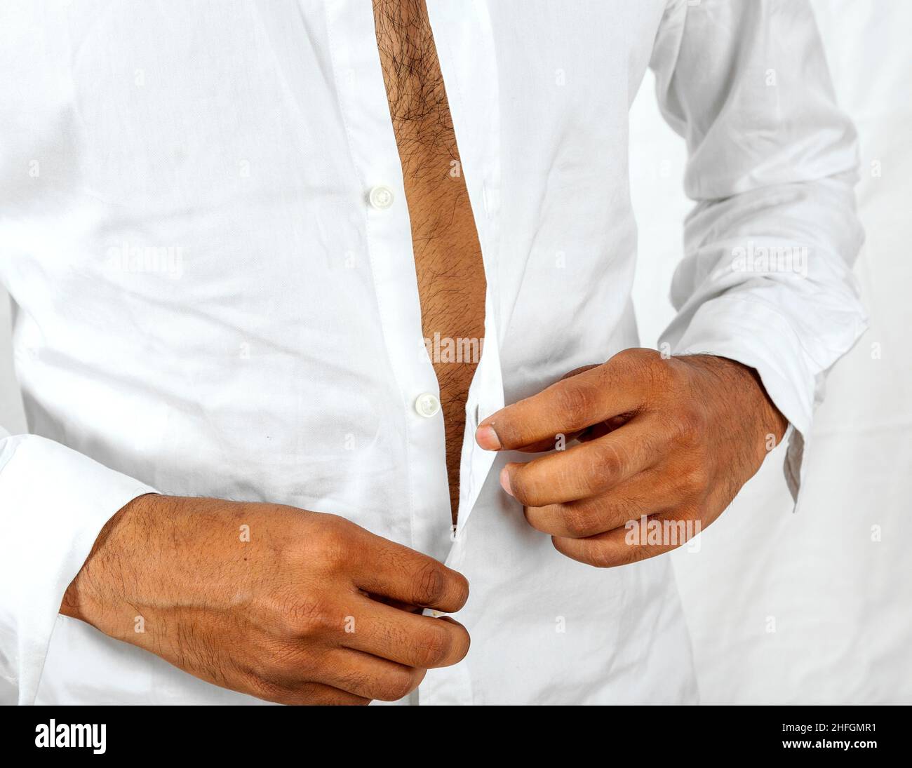 man buttoning his shirt Stock Photo - Alamy