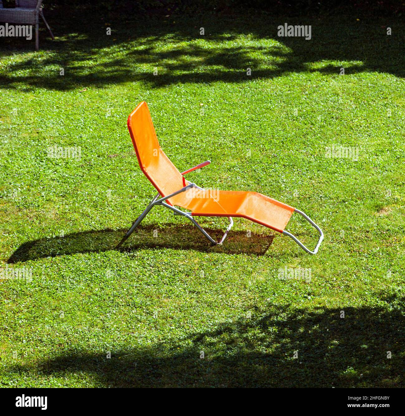 empty sun lounger in the garden at the grass Stock Photo - Alamy