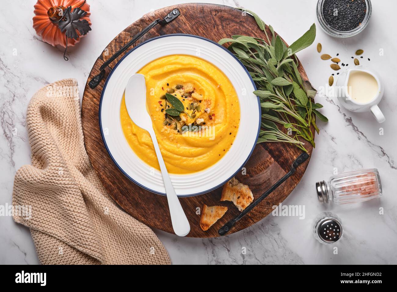 Pumpkin traditional soup with creamy silky texture with sage leaves and ...