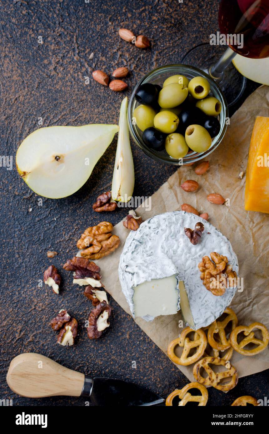 Camembert cheese close-up with honey, nuts, vine. Cheese with white ...