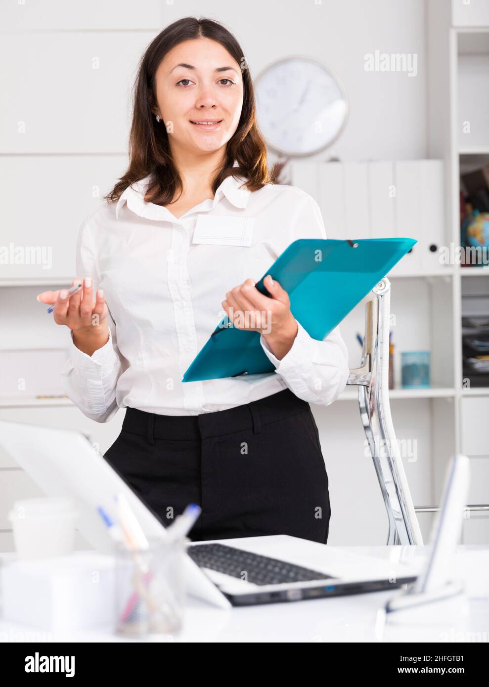 Young girl manager holding clipboard and inviting to working Stock ...