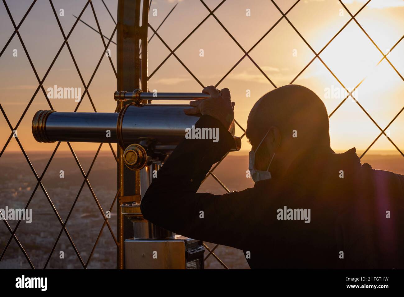 Young Man Looking trough Observation Binoculars in the Top Platform of ...