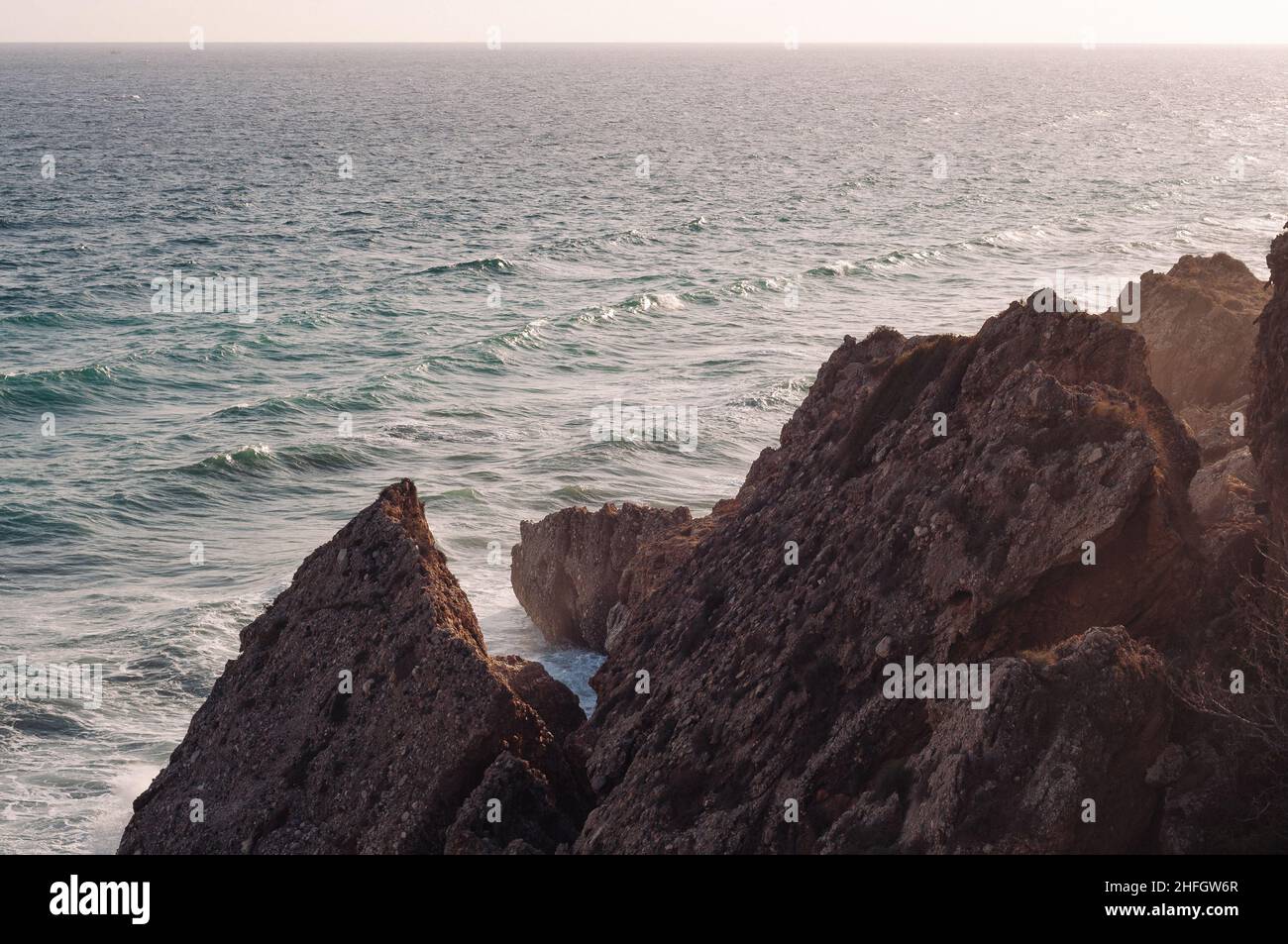 Sunset. Wild rock beach. The natural rock formation Stock Photo - Alamy