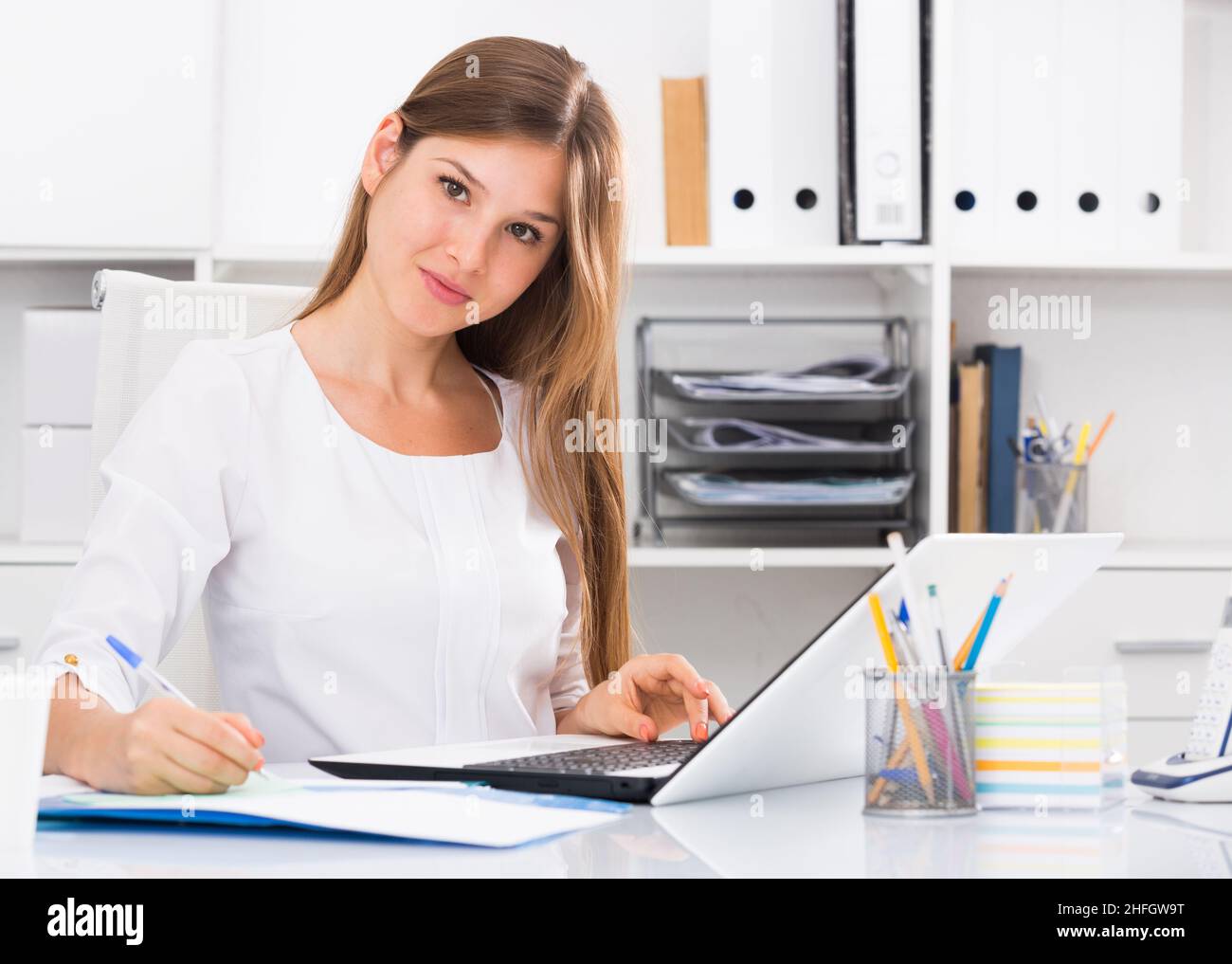 Woman working in office Stock Photo - Alamy