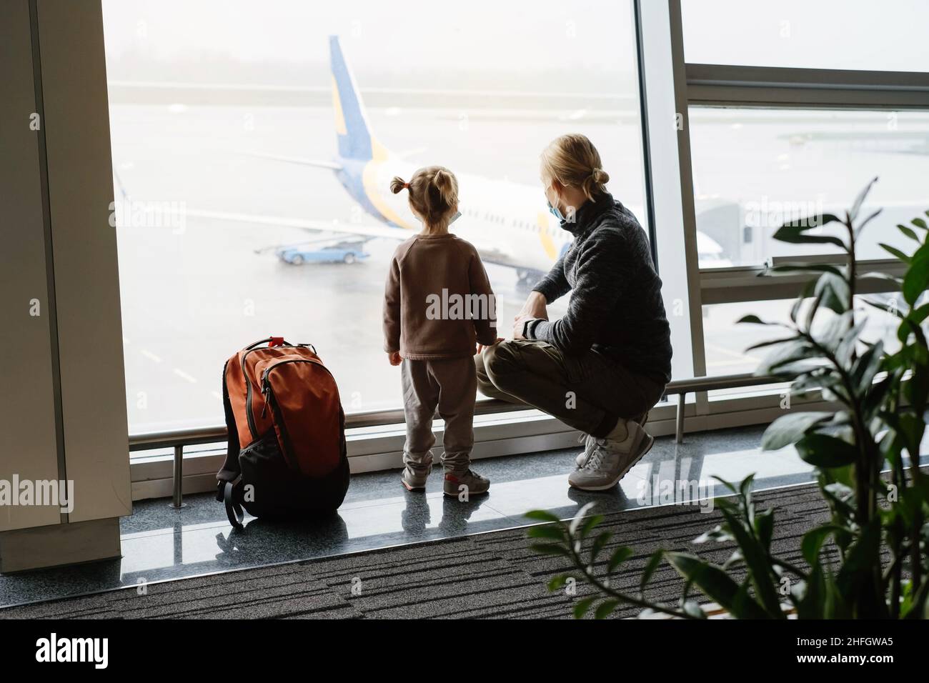 Man with girl ready to fly by airplane and the airport. Father and ...