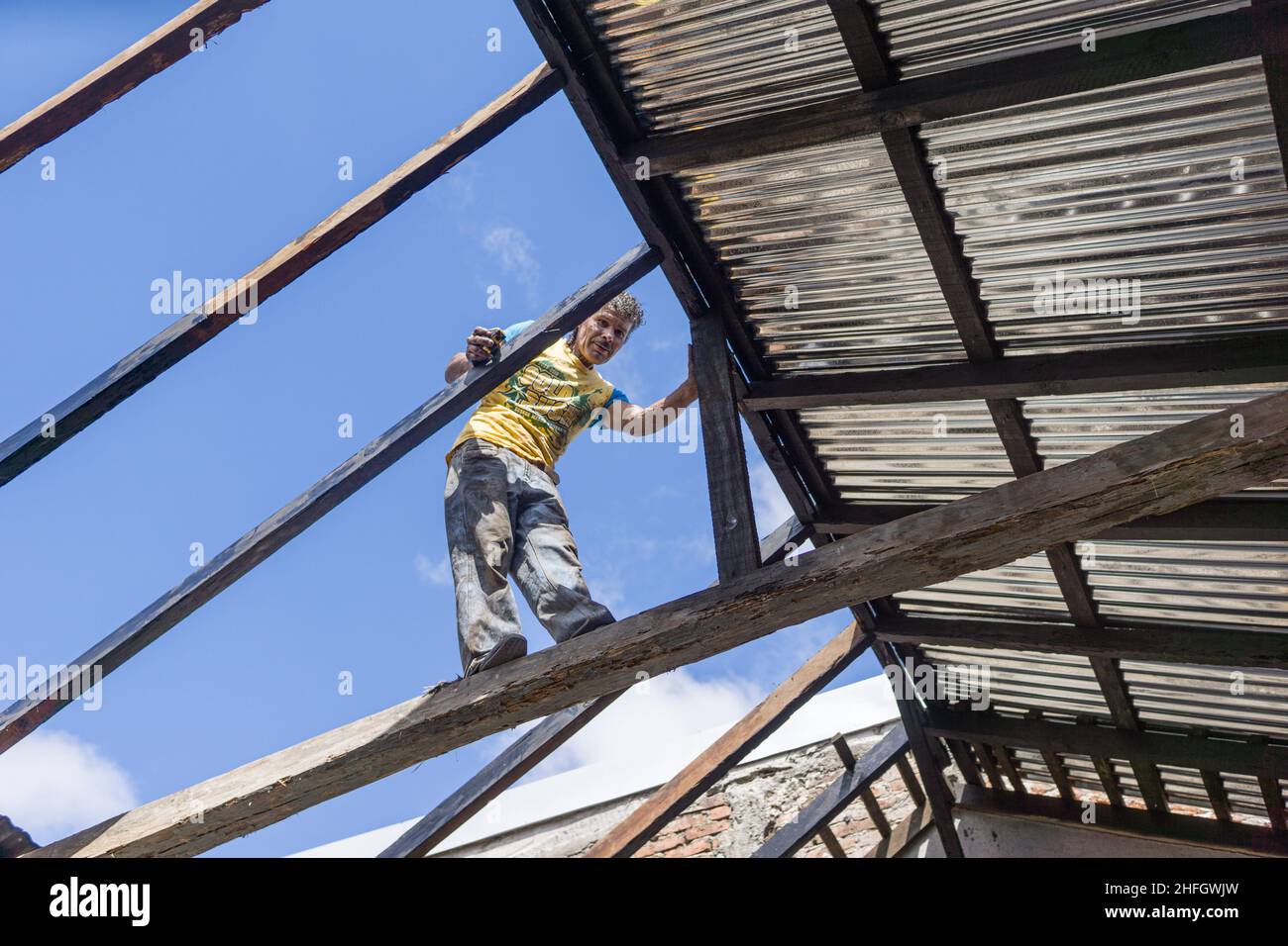 Man standing on roof beam hi-res stock photography and images - Alamy