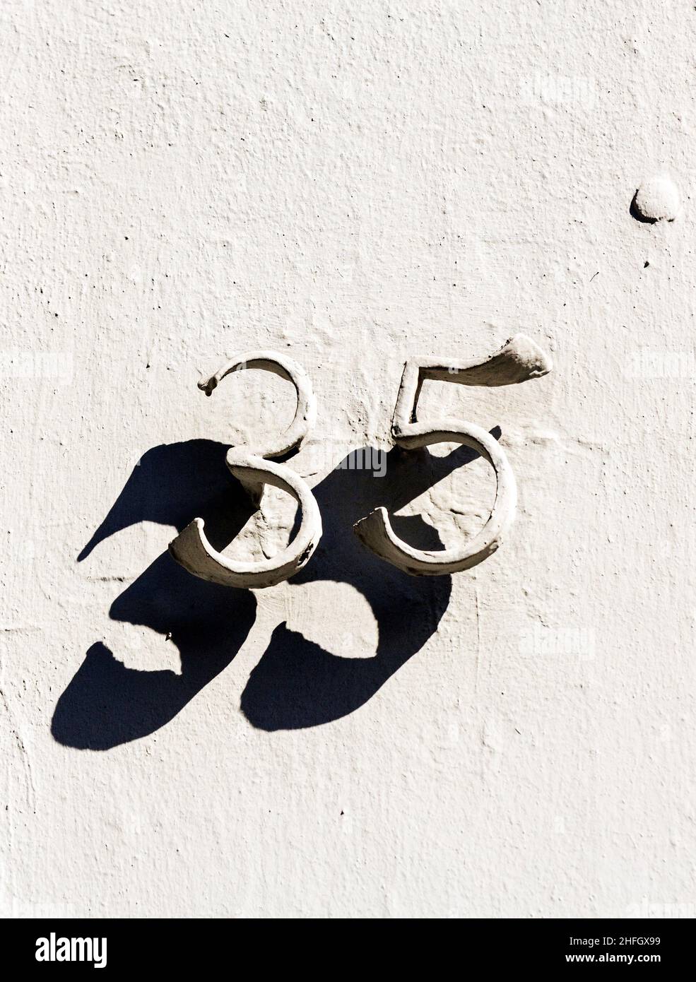 house number 35 at the wall with shadow Stock Photo - Alamy