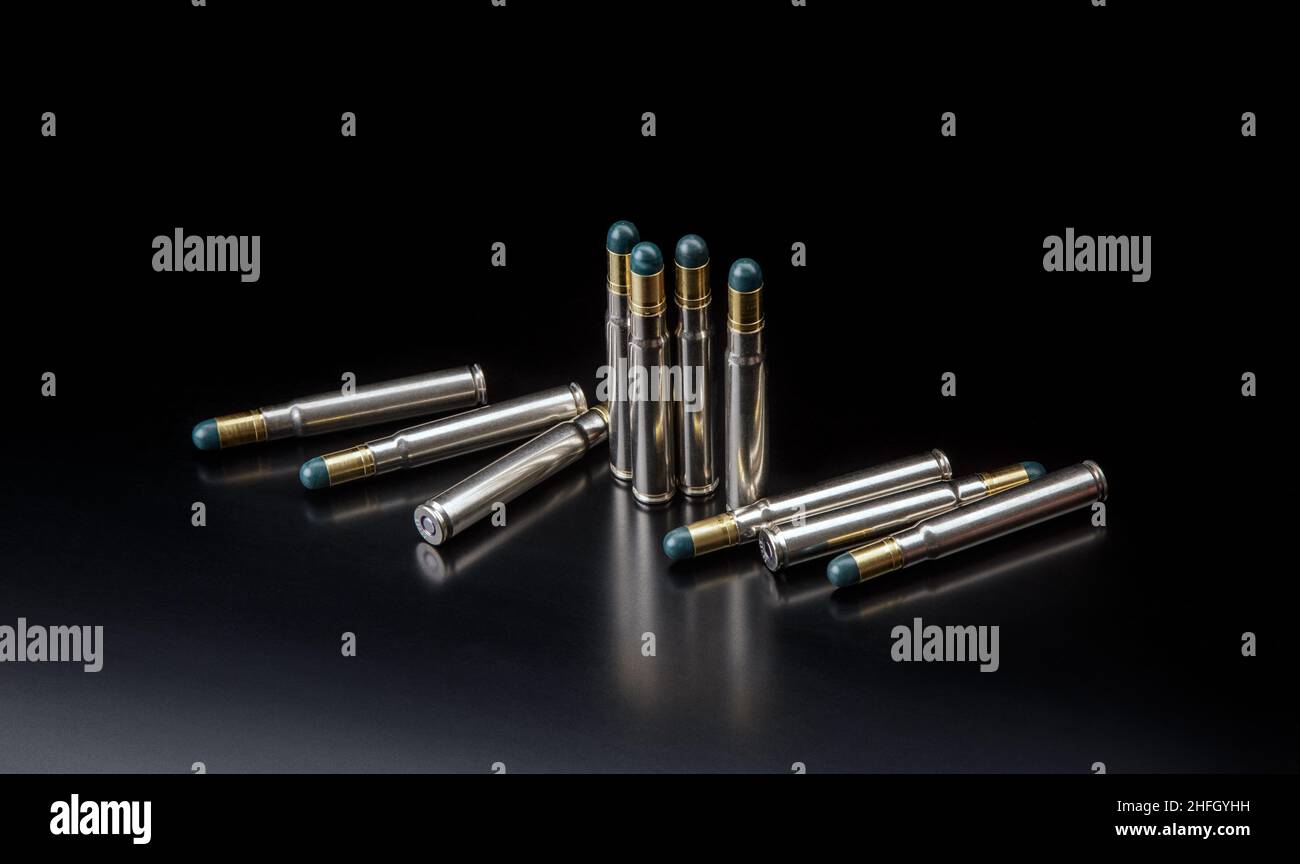 Bullet isolated on black background with reflexion. Rifle bullets close ...