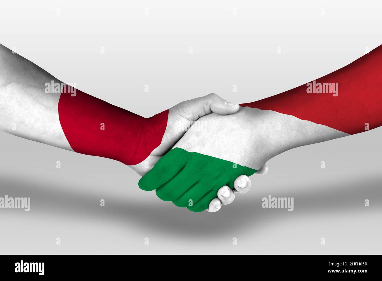 Handshake between germany and japan flags painted on hands ...