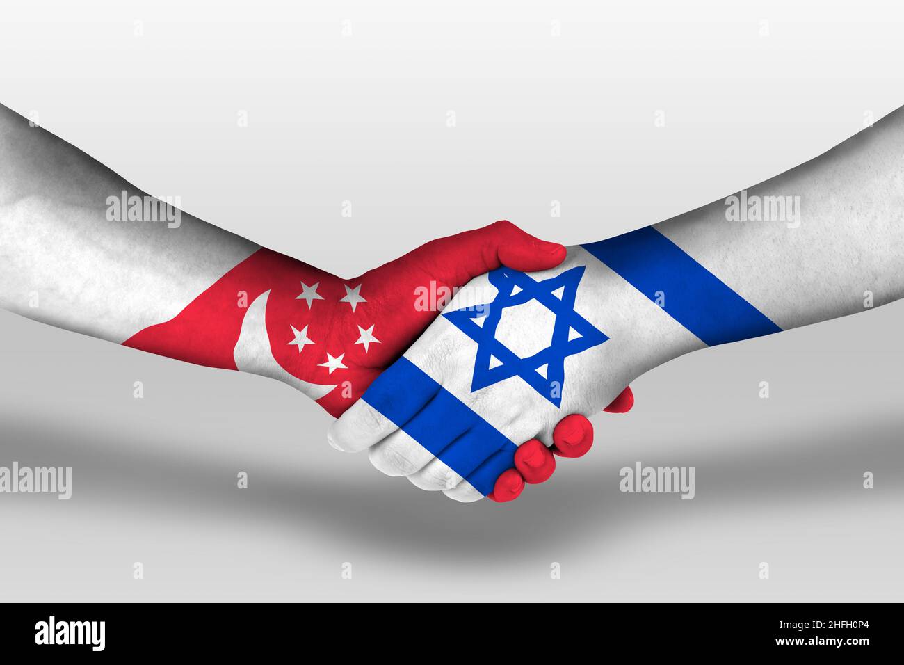 Handshake between iraq and singapore flags painted on hands ...