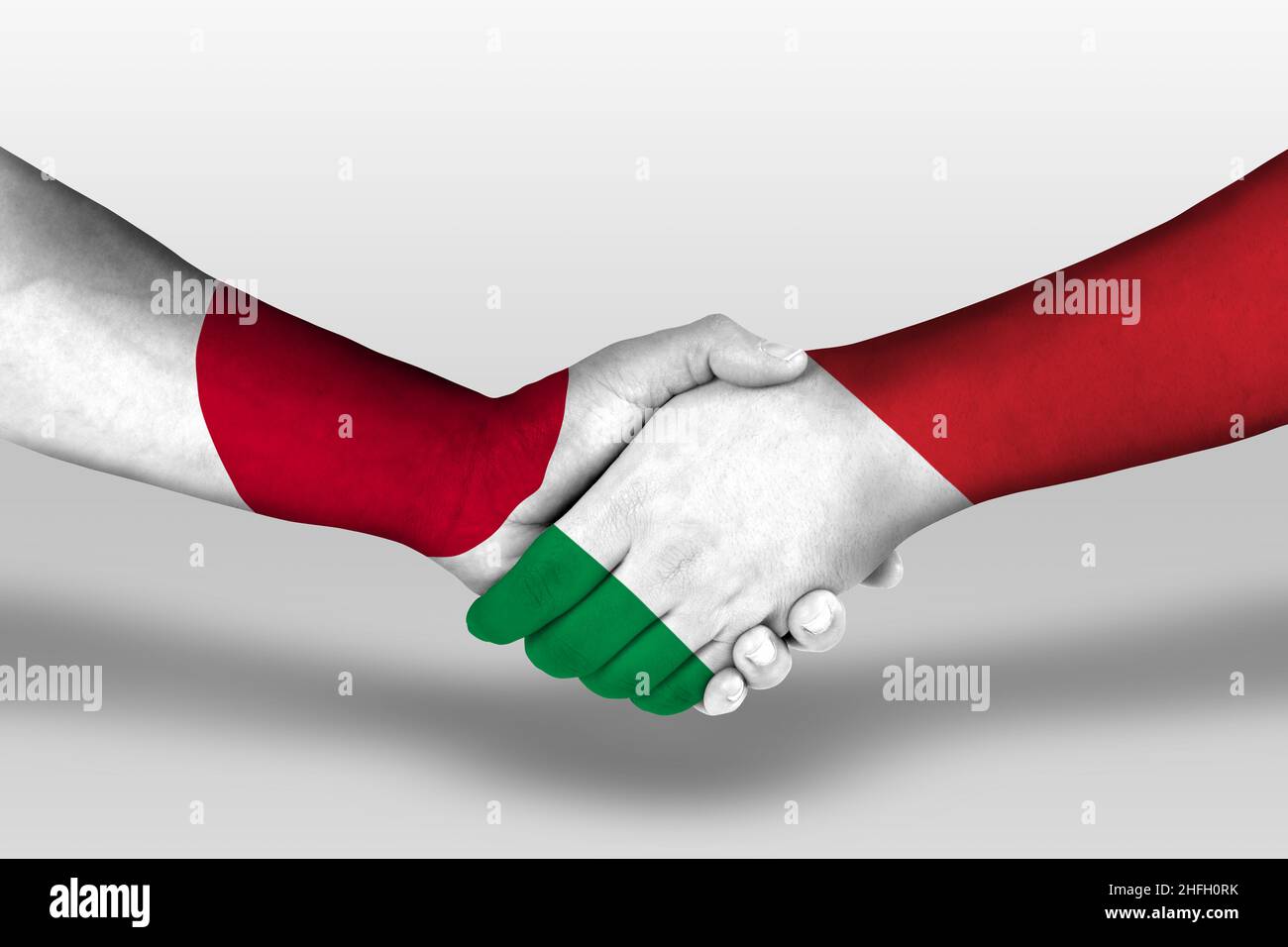 Handshake between ireland and japan flags painted on hands ...