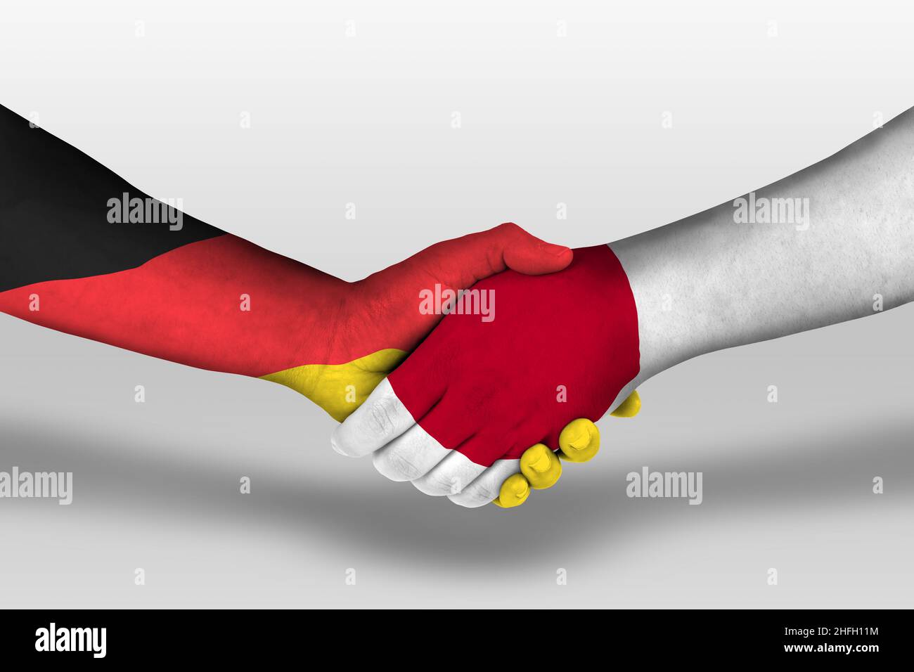 Handshake between japan and germany flags painted on hands ...