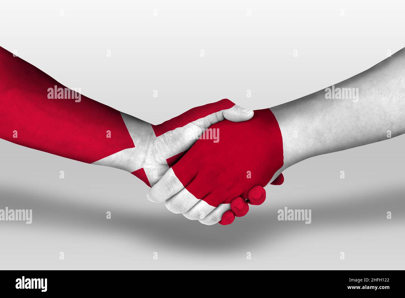 Handshake between japan and denmark flags painted on hands ...