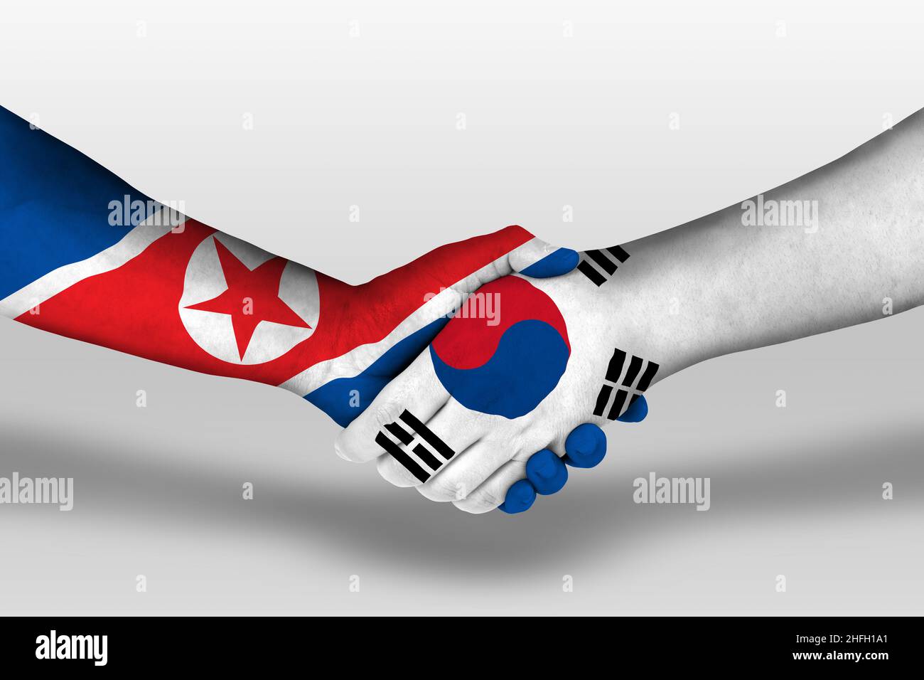 Handshake between south korea and north korea flags painted on hands ...