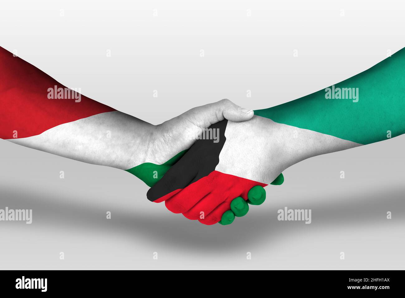 Handshake between kuwait and hungary flags painted on hands ...