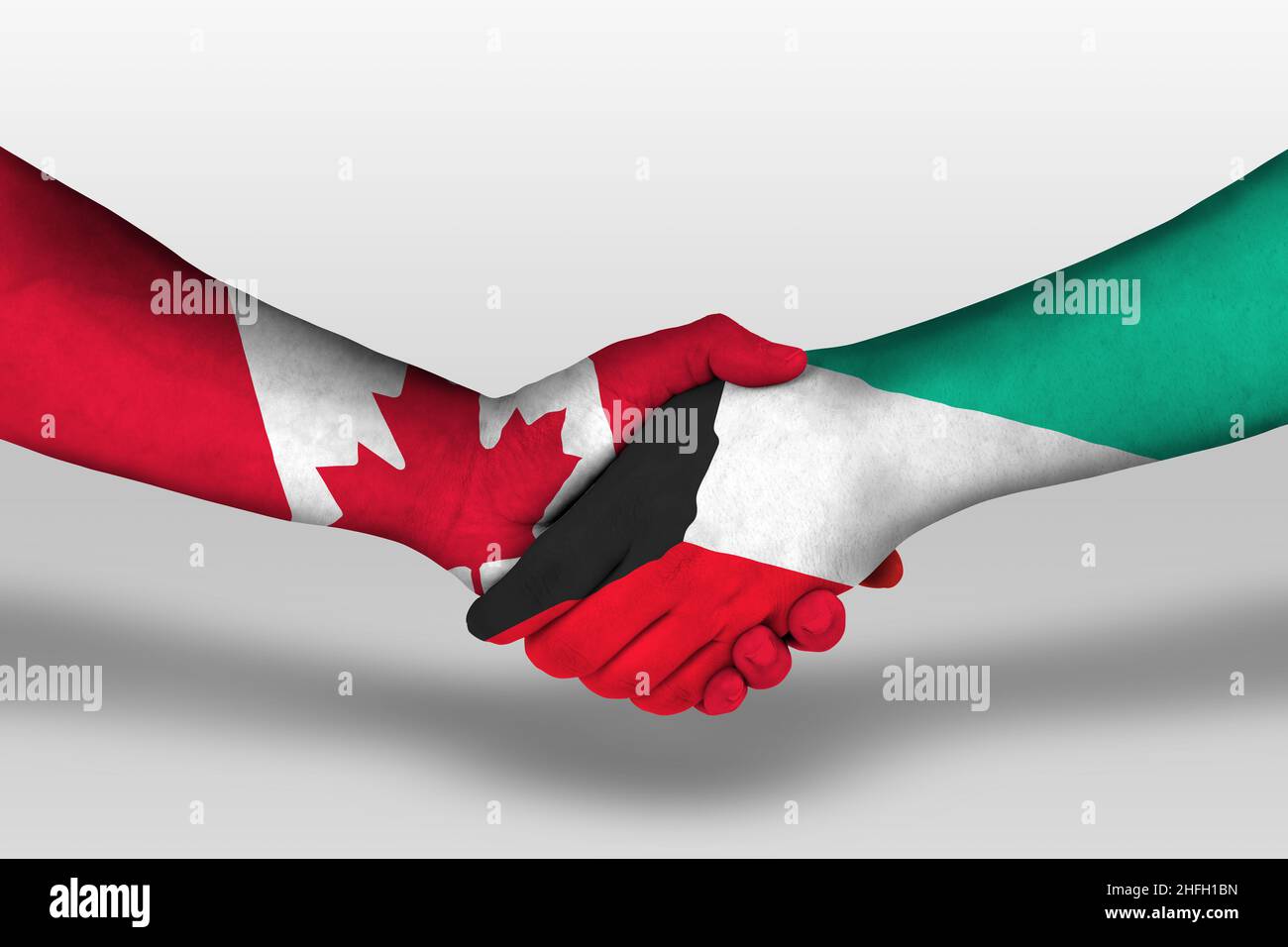 Handshake between kuwait and canada flags painted on hands ...