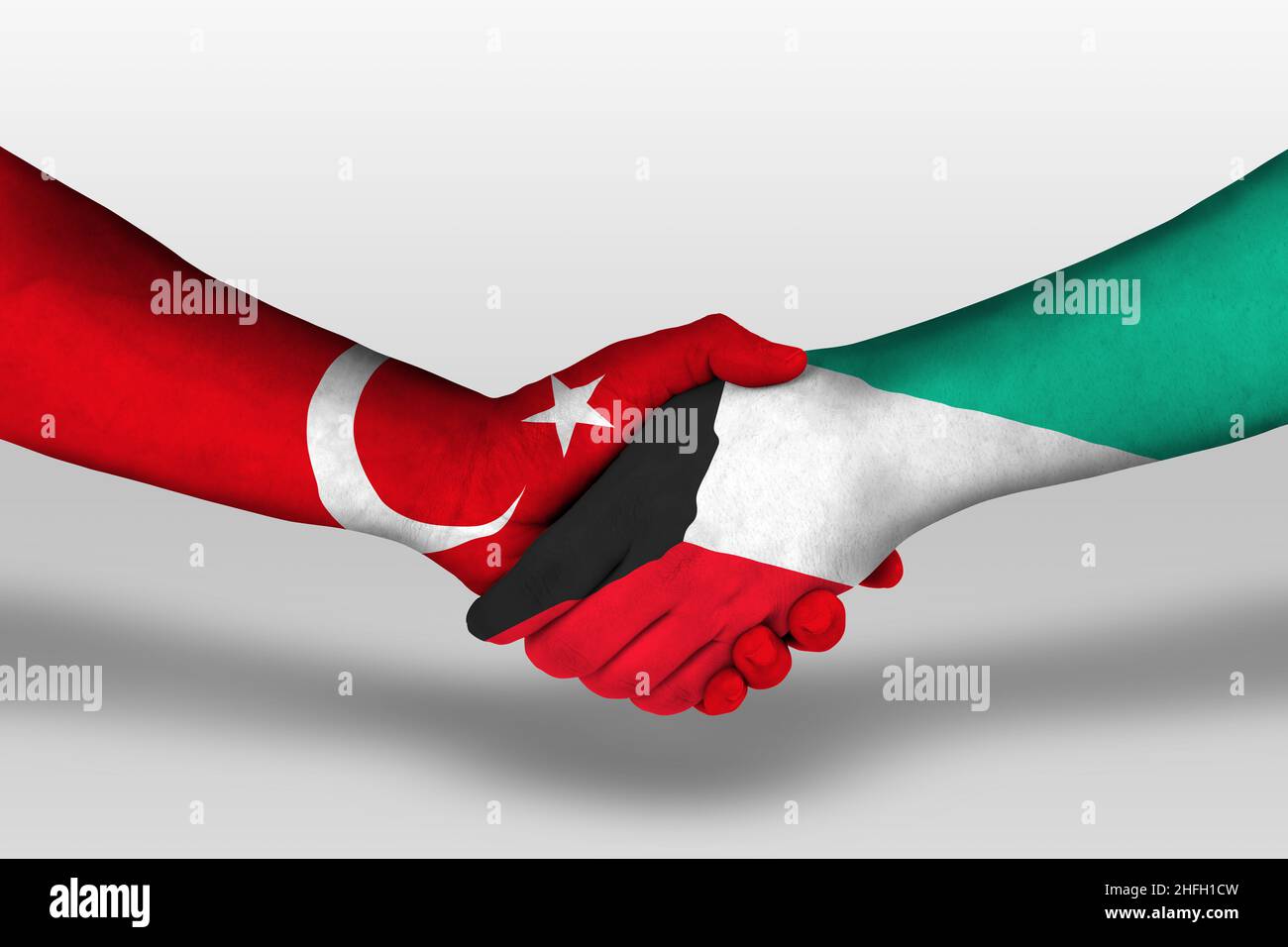 Handshake between kuwait and turkey flags painted on hands ...
