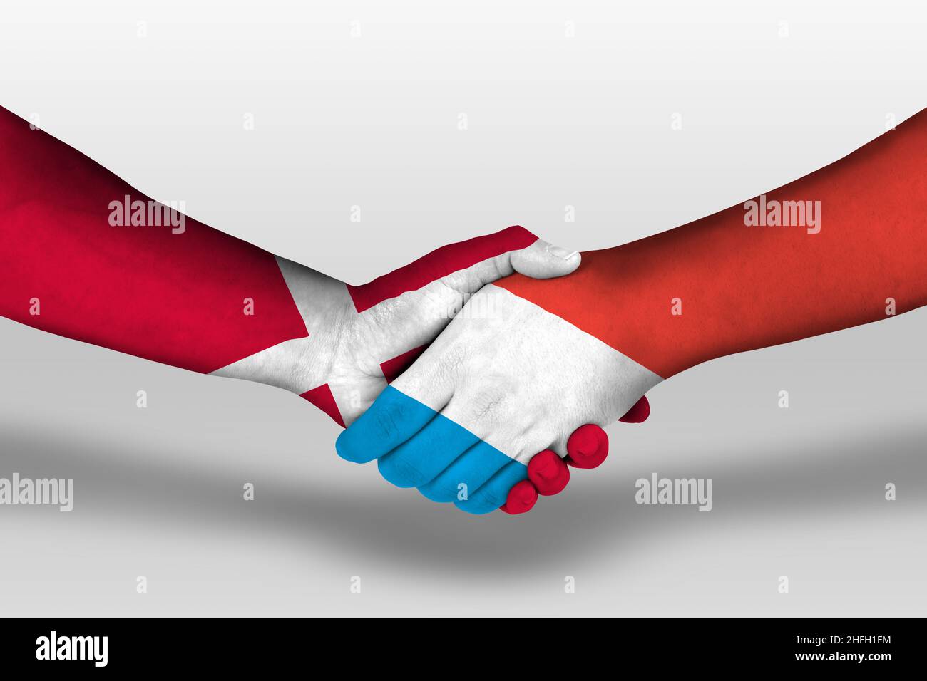 Handshake between luxembourg and denmark flags painted on hands ...