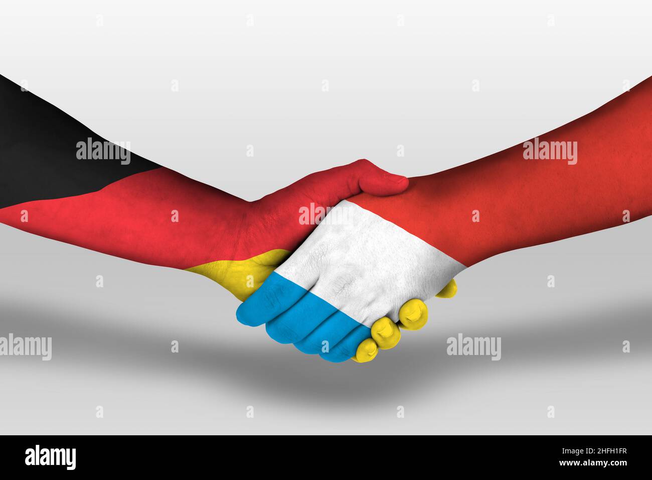 Handshake between luxembourg and germany flags painted on hands ...