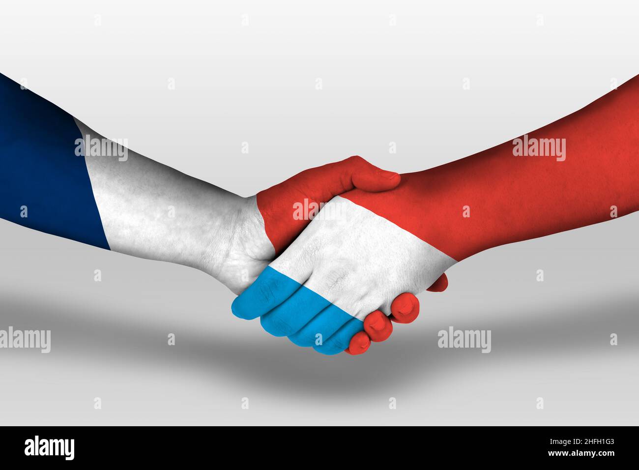 Handshake between luxembourg and france flags painted on hands ...
