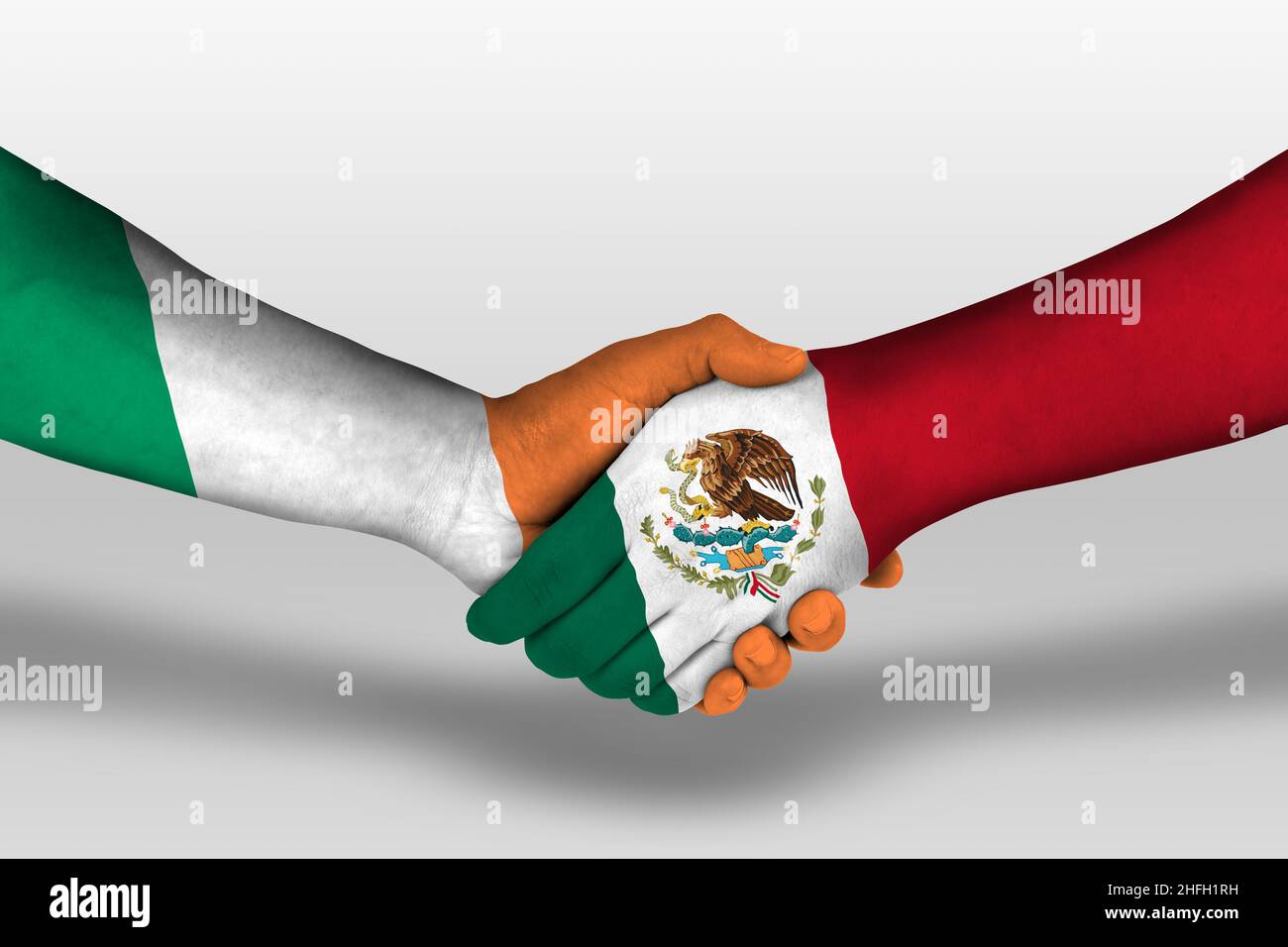 Handshake between mexico and ireland flags painted on hands ...